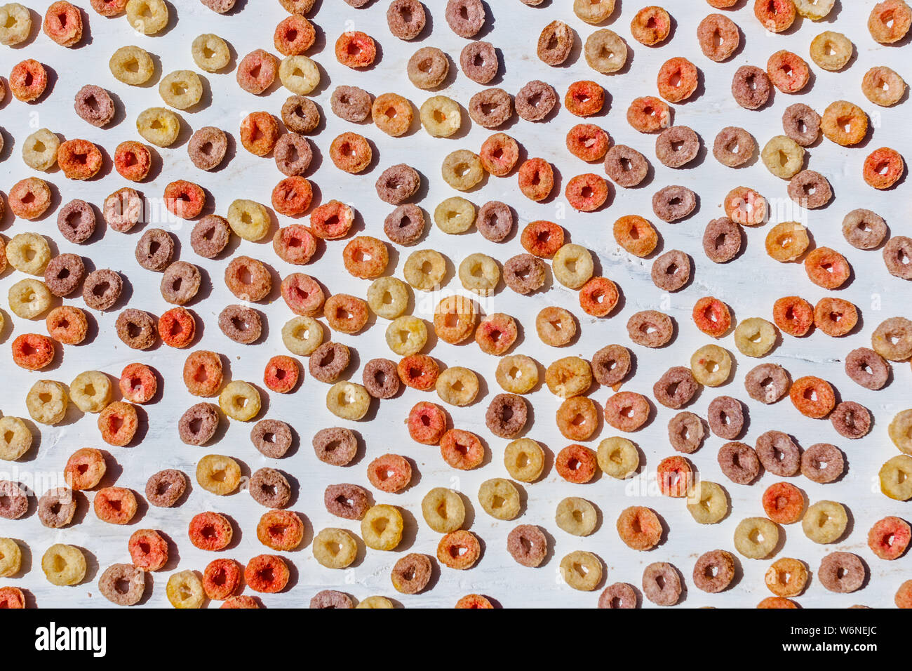 Colorful breakfast fruit loops on white background Stock Photo - Alamy