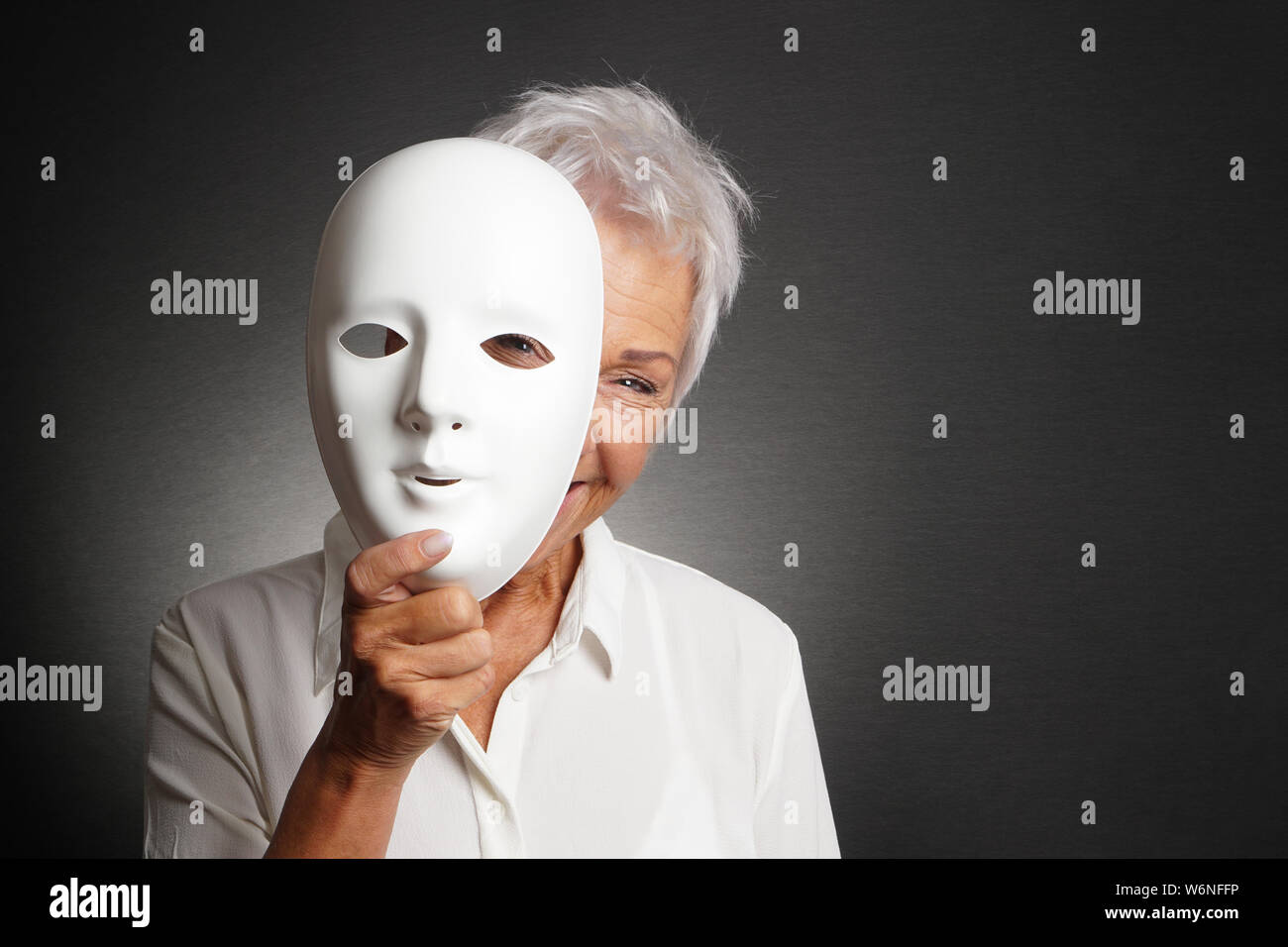 Smiling behind mask hi-res stock photography and images - Alamy