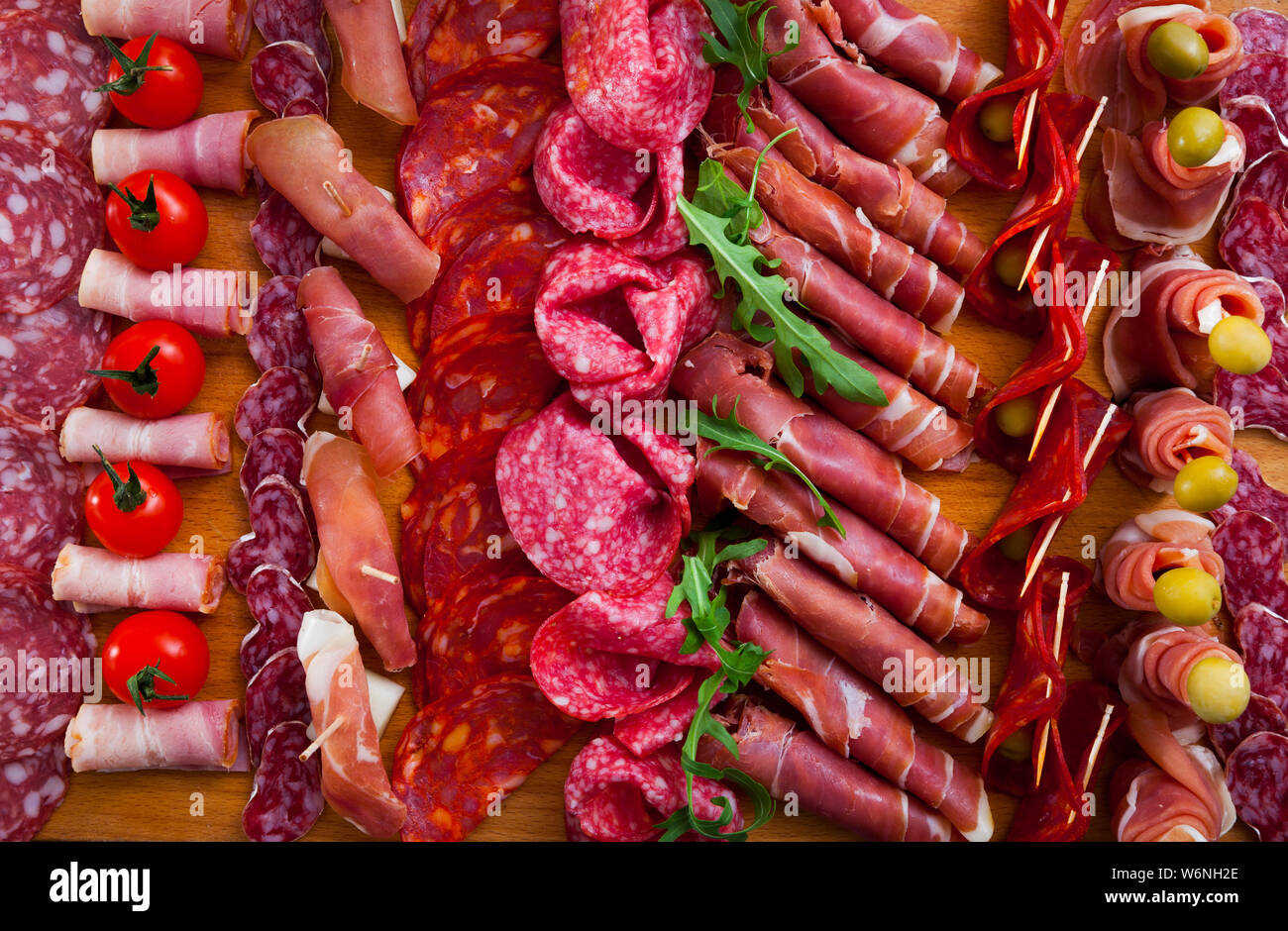 Spanish sausage cutting – fuet, jamon, chorizo, olives on wooden board ...