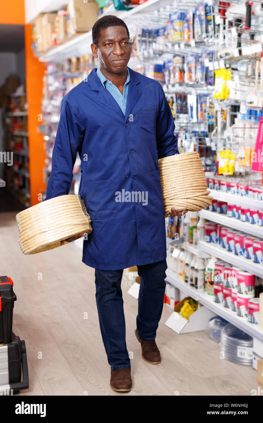 Confident happy cheerful glad African-American handyman choosing ...