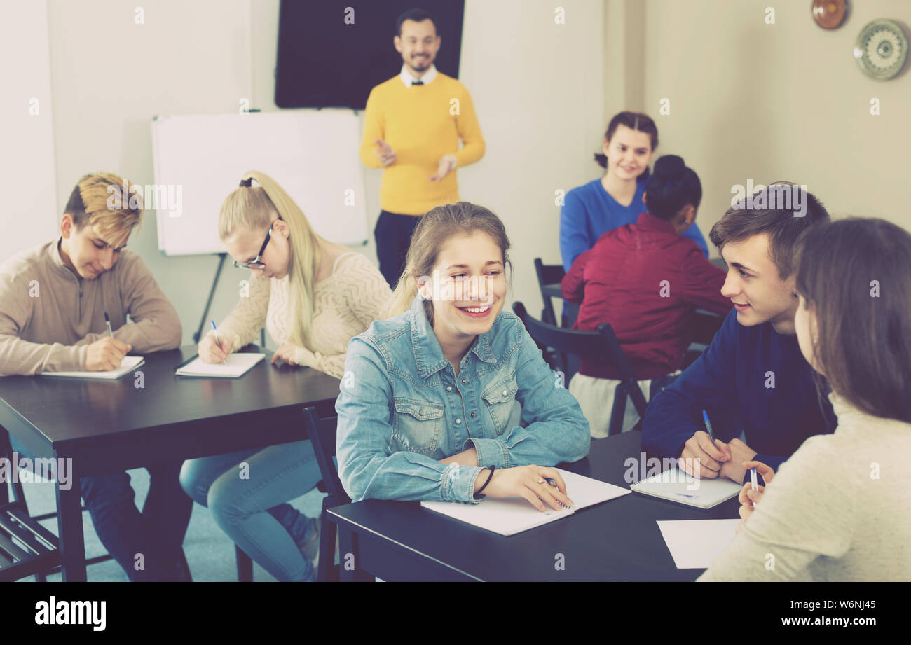 Girls and boys students are having group exercises in school Stock ...