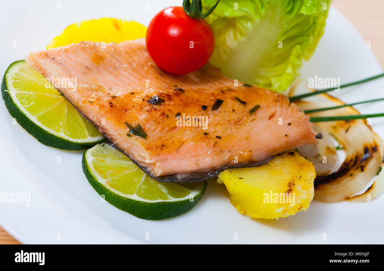 Image of tasty fried trout fillets served with cherry tomatoes ...