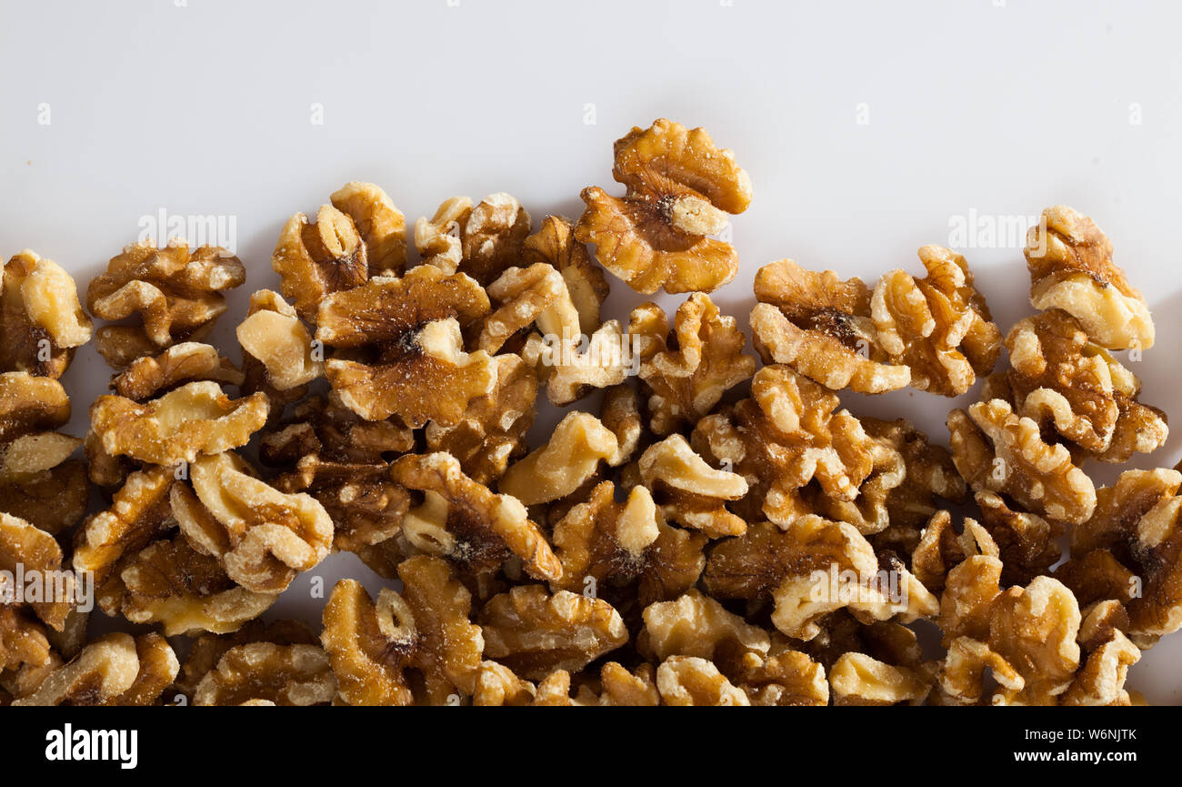 Closeup of raw shelled walnuts on white background. Concept of healthy ...
