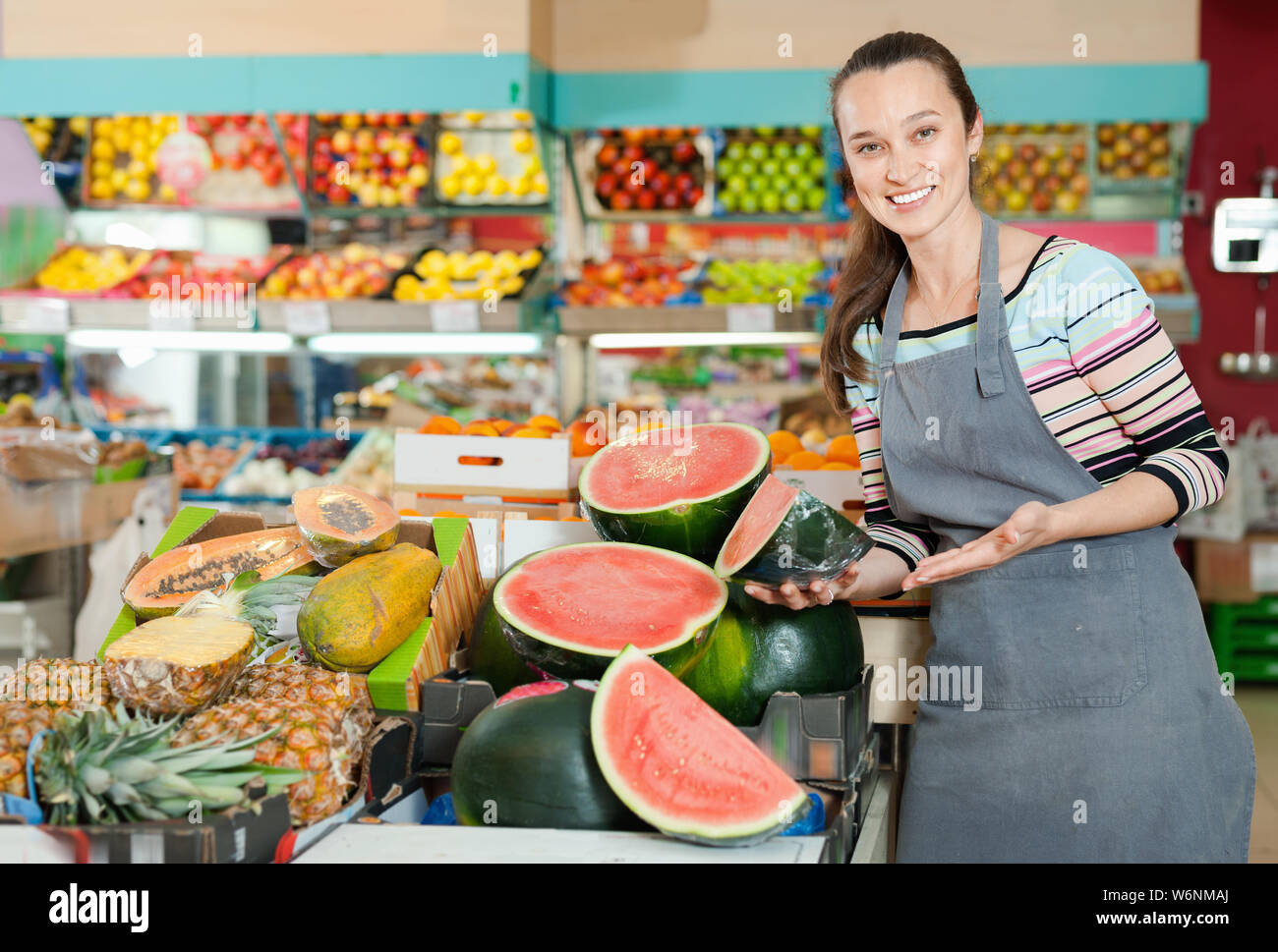 Happy smiling Caucasian female store employee at fruit department Stock ...