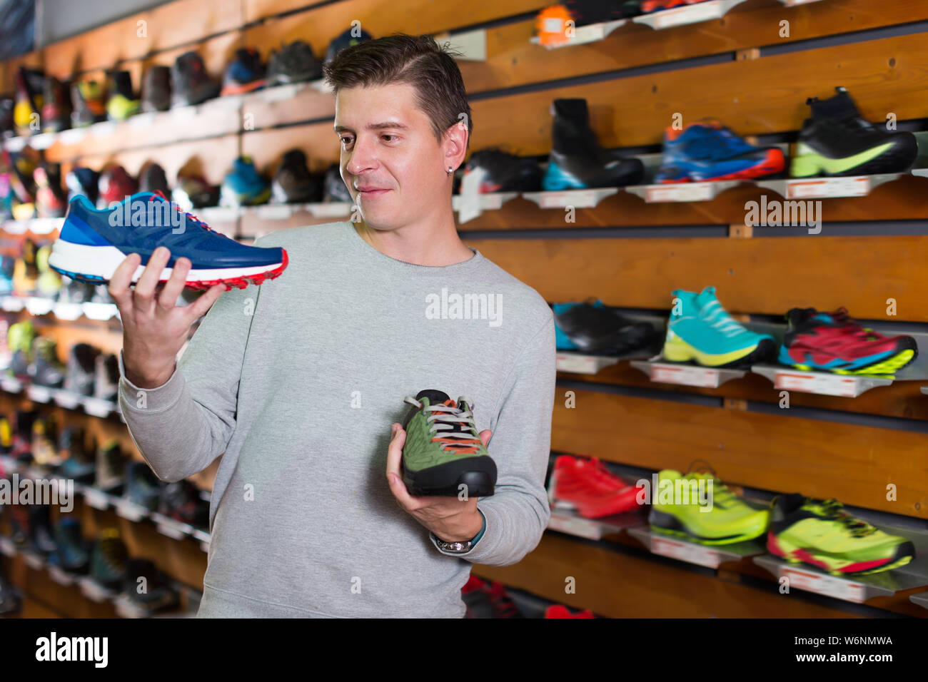 Man chooses shirt in mall hi-res stock photography and images - Alamy