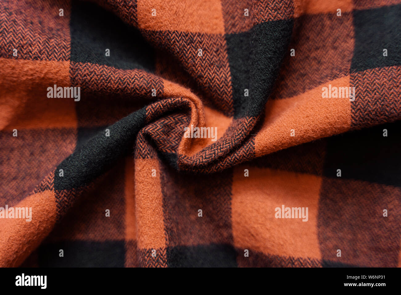 Wrinkled black and orange cell clothes background. Fabric with black ...