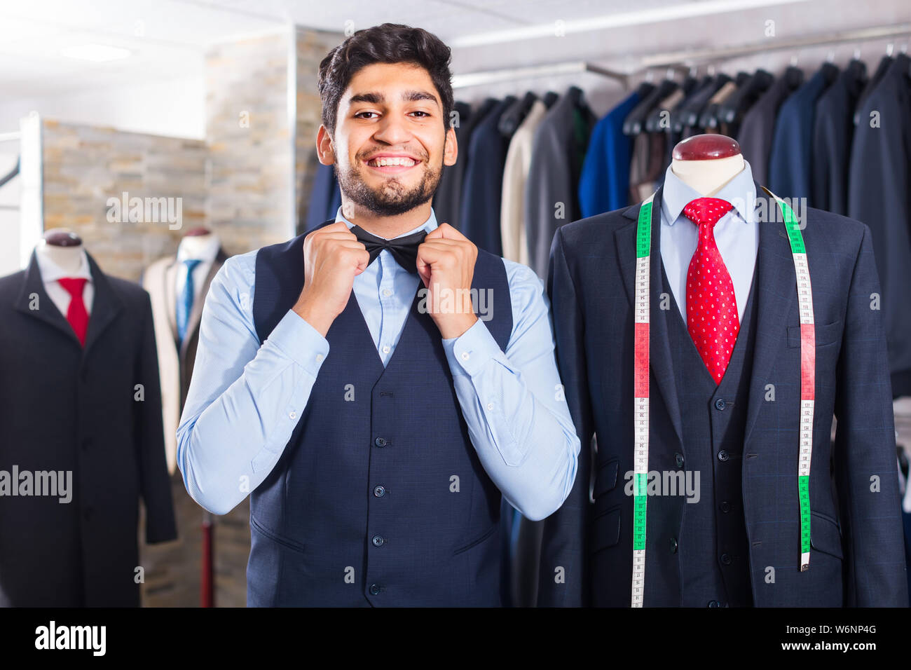 Male designer is pleased by created image in men's shop Stock Photo - Alamy