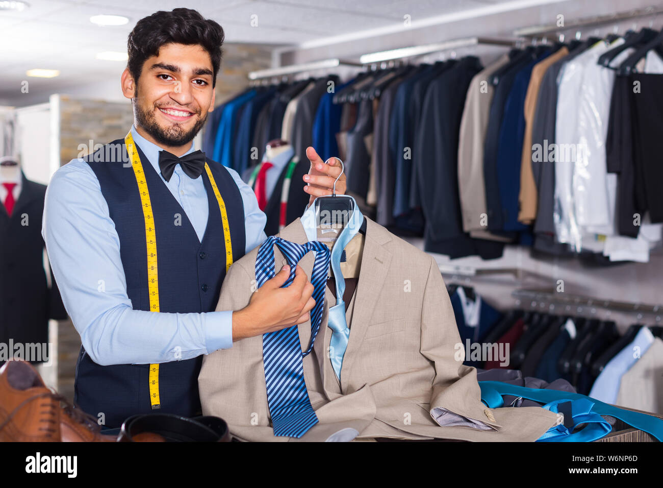 Designer is picking up a tie for light jacket in the shop Stock Photo ...