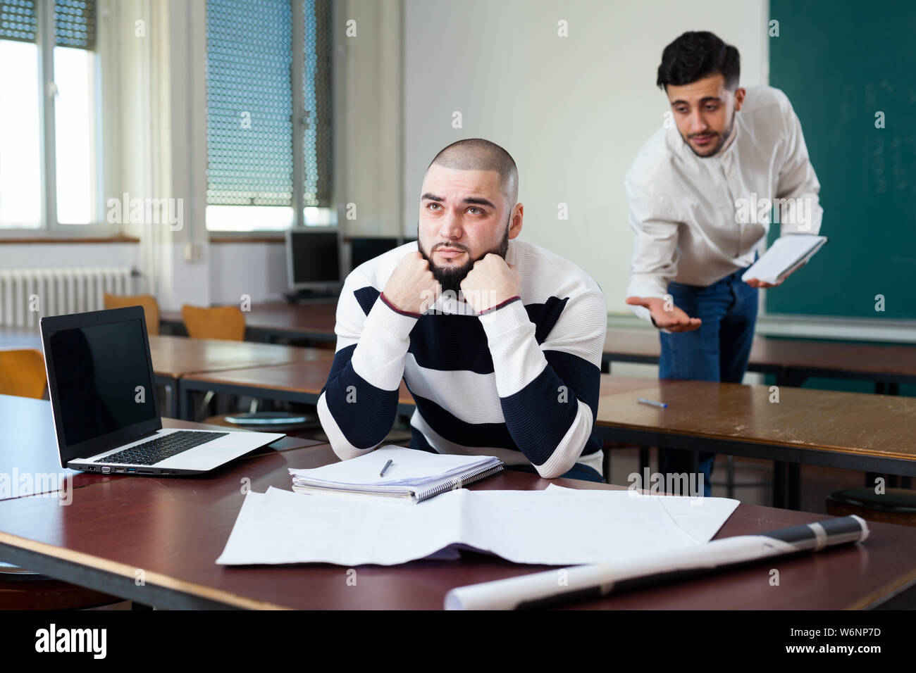 Male student having difficulties with studies and his friend trying to ...