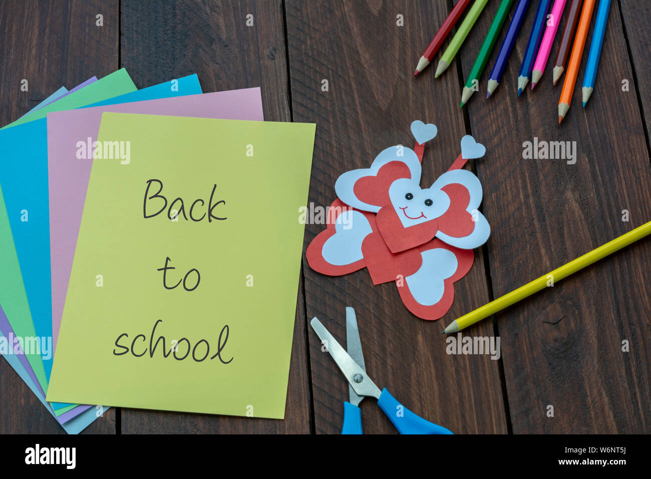 Desk with stationary and with Back to school sign. Studio shot on ...