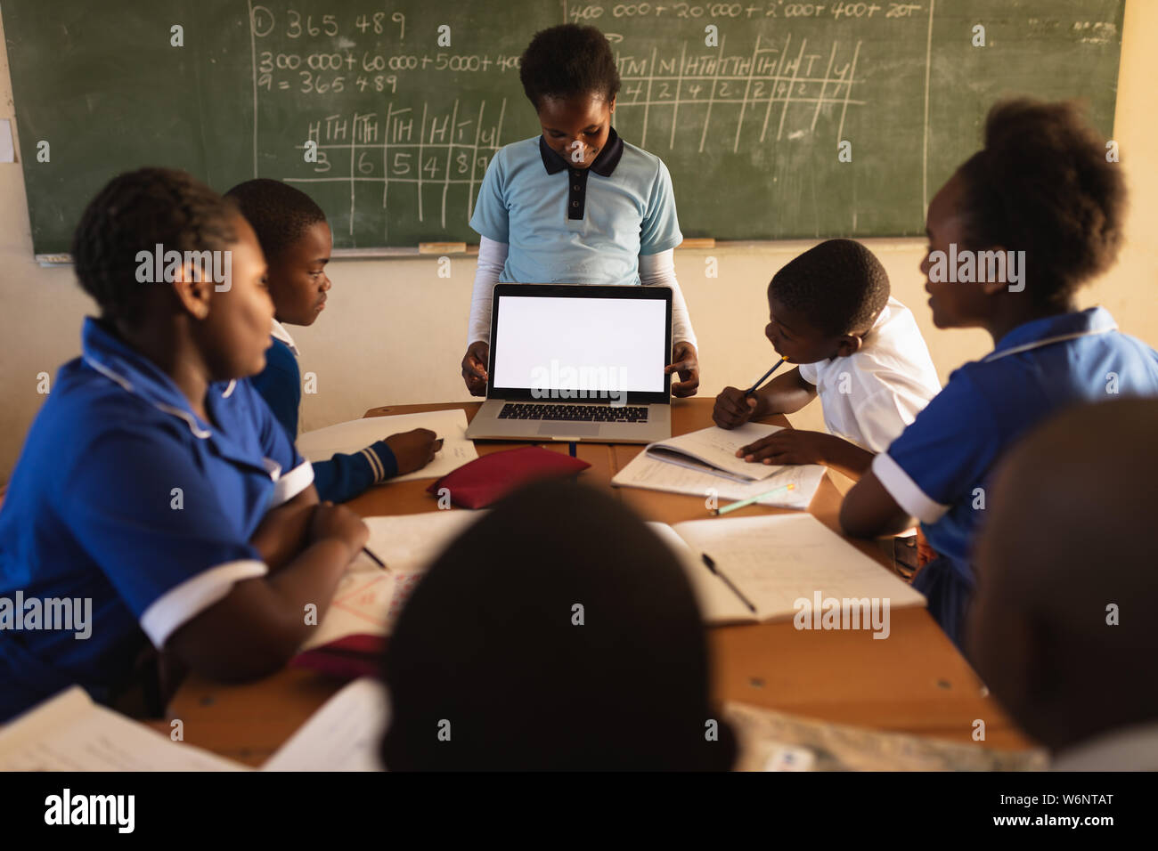 Young schoolboy with laptop at the front of class Stock Photo - Alamy