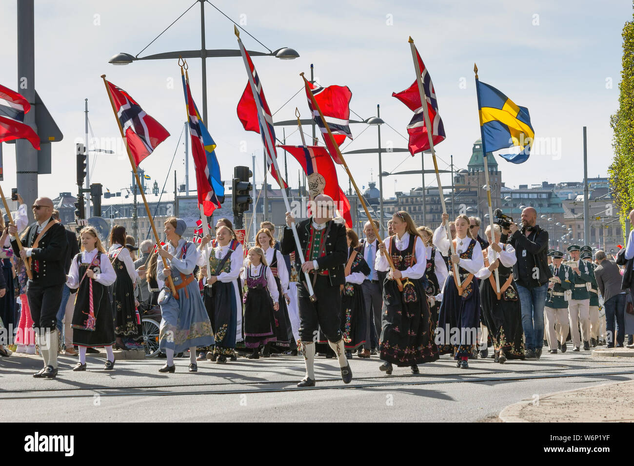 Norwegian patriots holding national flags and parade crowd in during ...