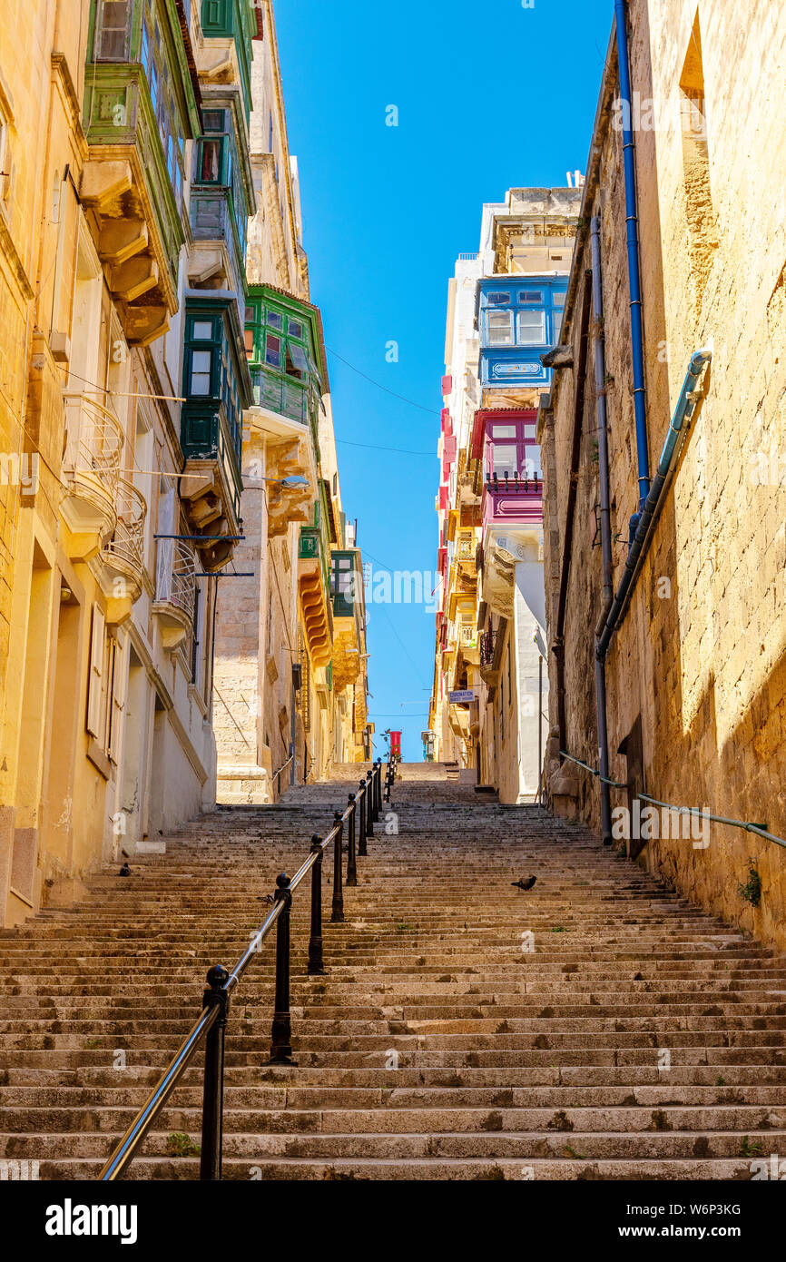 Maltese narrow street with long staircase in Valletta, Malta Stock ...