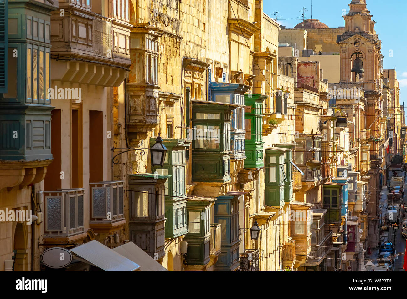 Typical narrow maltese streets with colorful traditional windows and ...