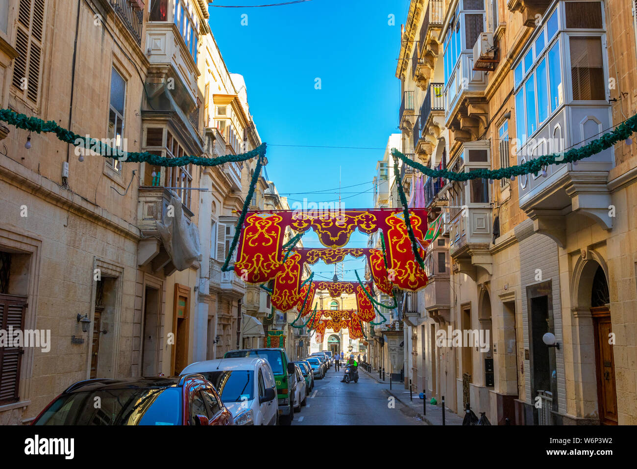 Typical narrow maltese streets with colorful traditional windows and ...