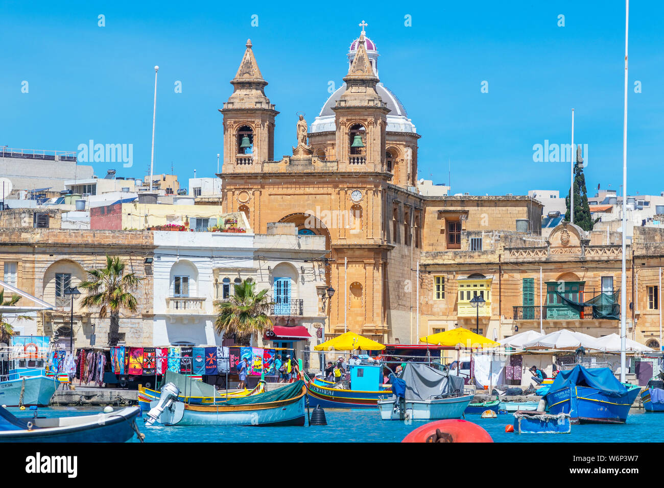 The traditional luzzu boats in the harbor of fishing village Marsaxlokk ...