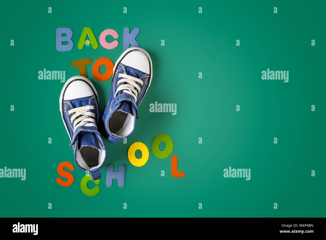 Back to school concept with old sneakers. Children sport shoes and ...