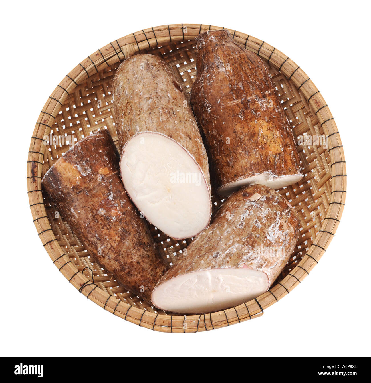 sliced manioc (cassava) in bamboo basket isolated on white background ...