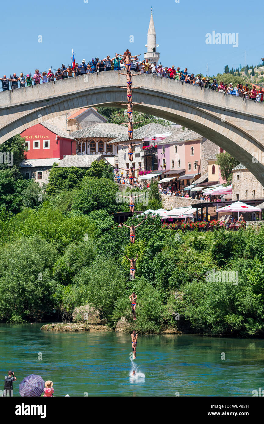 Guy jumping of the 19 meter high old bridge (Stari Most) in Mostar ...