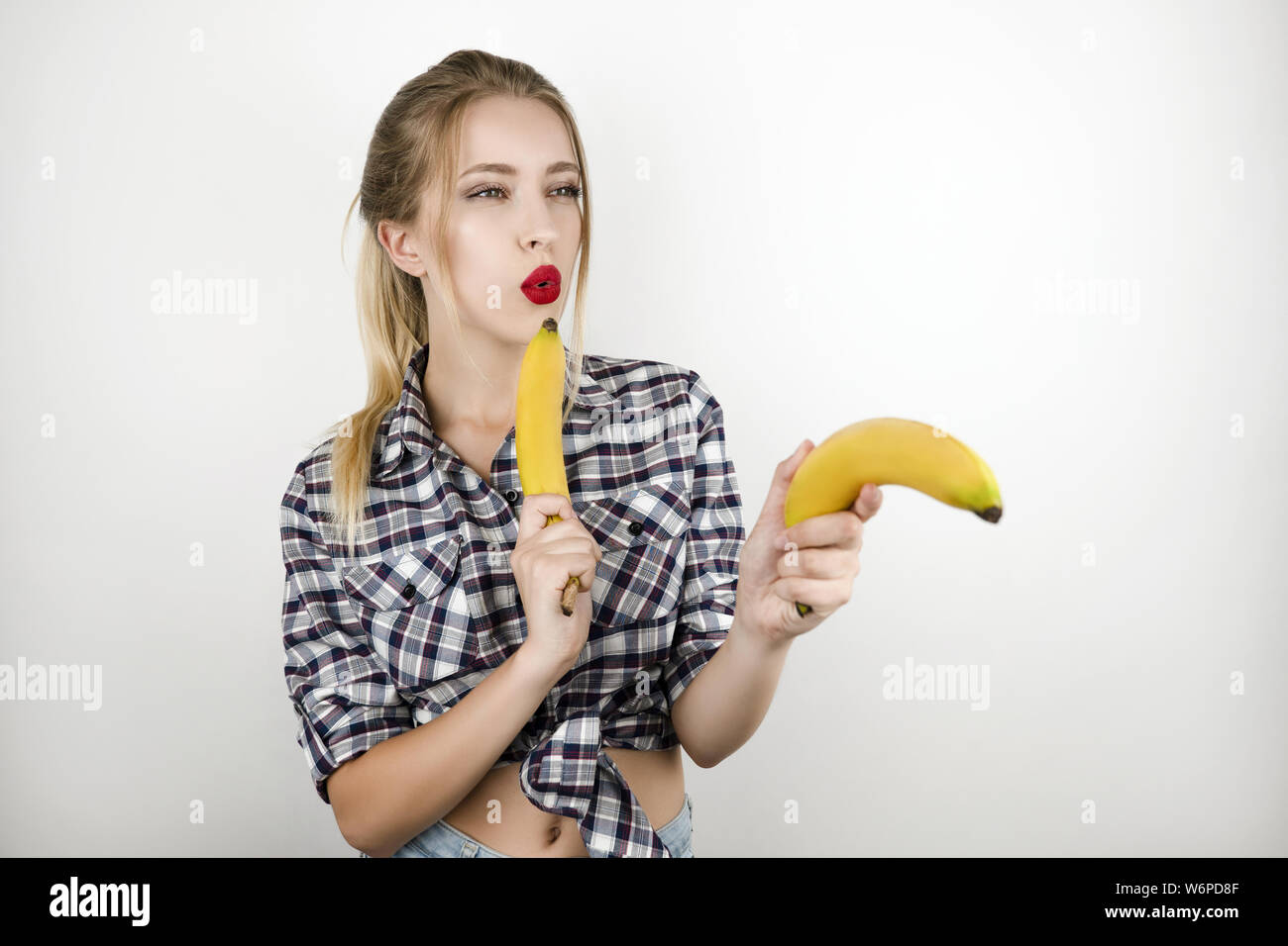 young beautiful blonde woman wearing trendy checkered shirt and denim ...
