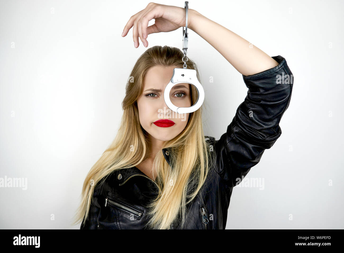 young beautiful blonde woman wearing black leather jacket looks ...