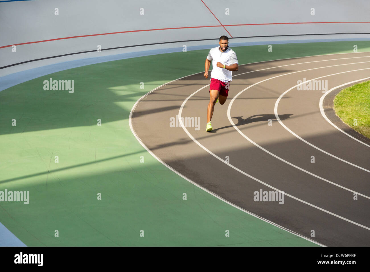 African American athlete running on the running track Stock Photo - Alamy