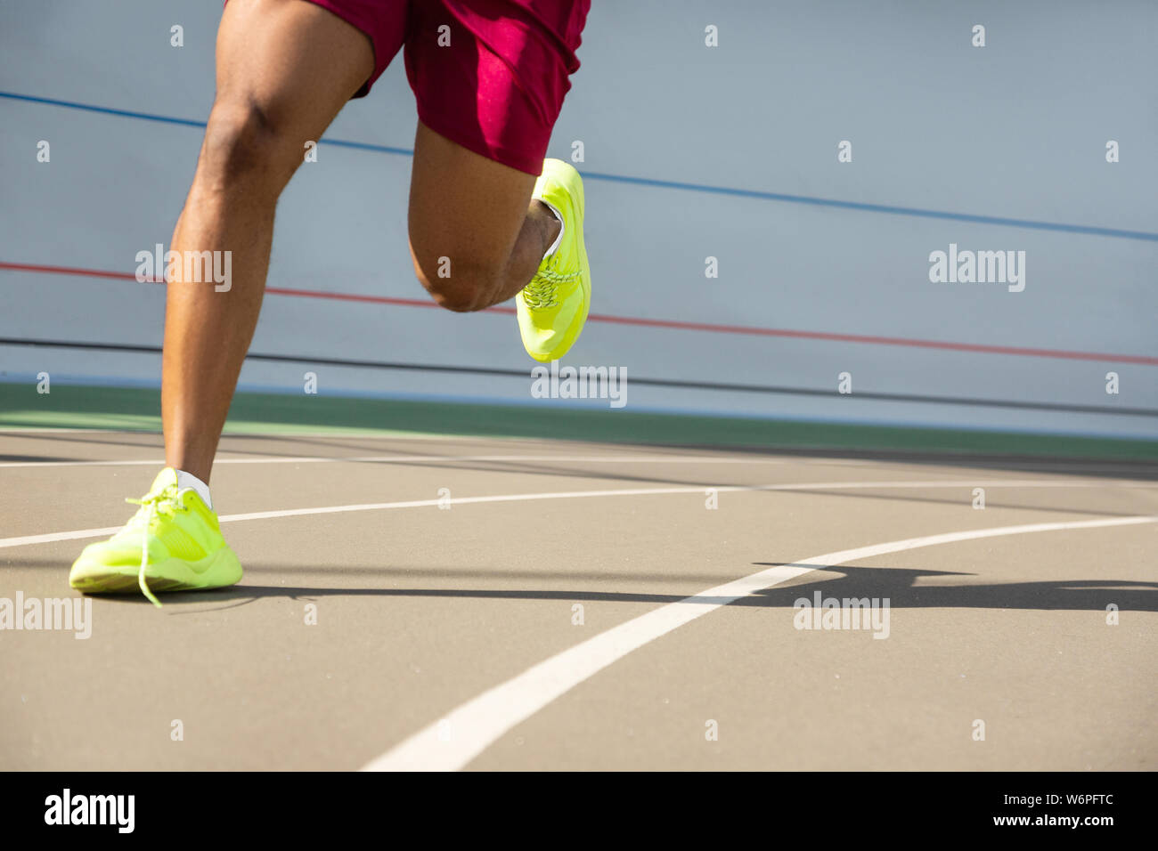 Fit male athletes legs running at the stadium Stock Photo - Alamy