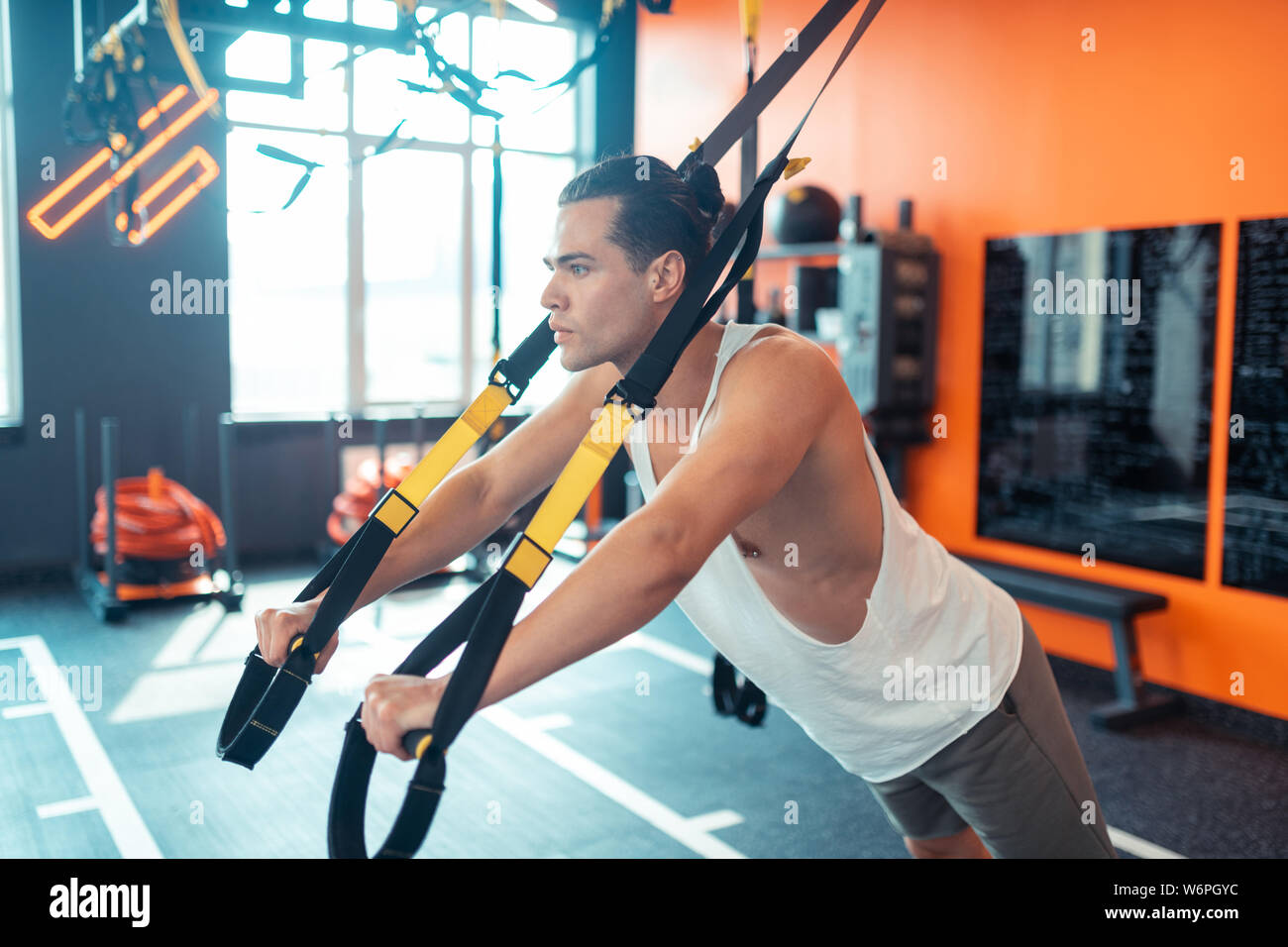Good looking well built man having a trx training Stock Photo - Alamy
