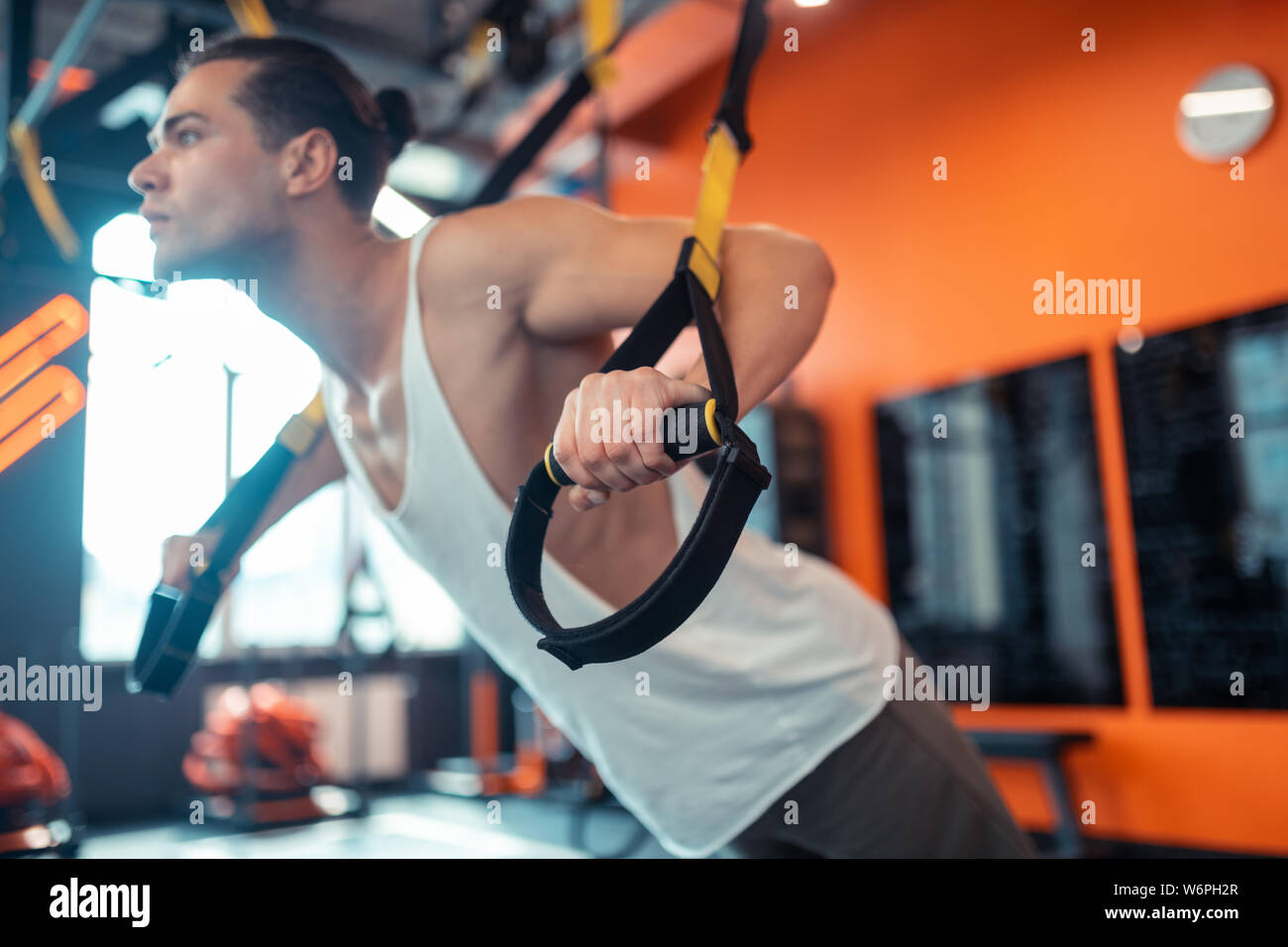 Selective focus of a male hand holding trx strap Stock Photo - Alamy