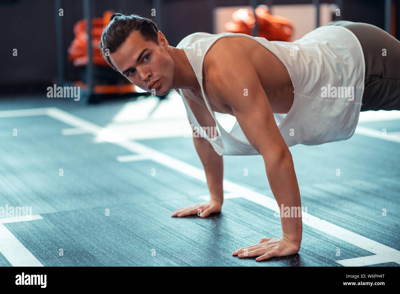 Serious well built man putting his hands on the floor Stock Photo - Alamy