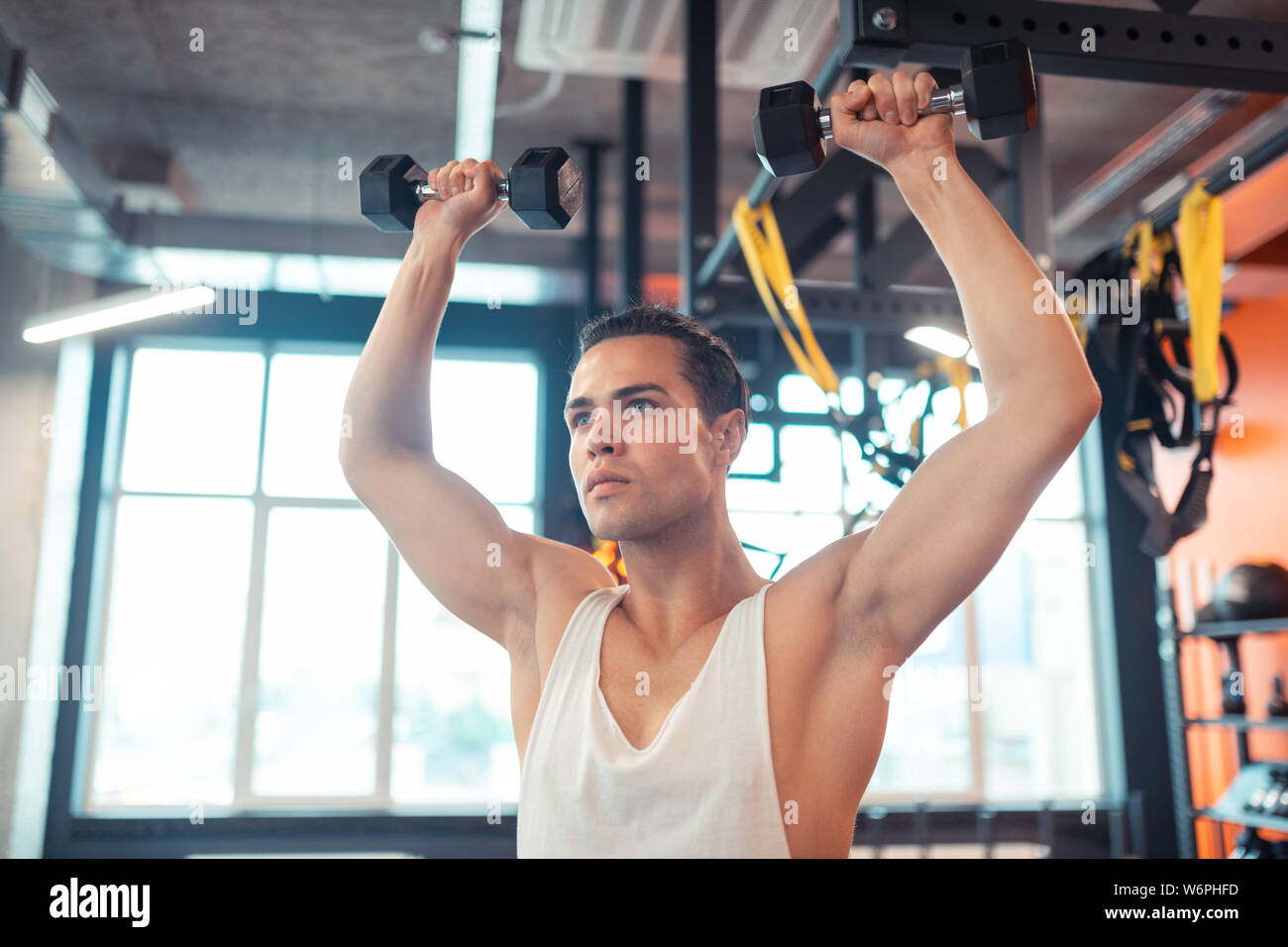 Serious hard working man developing his body Stock Photo - Alamy