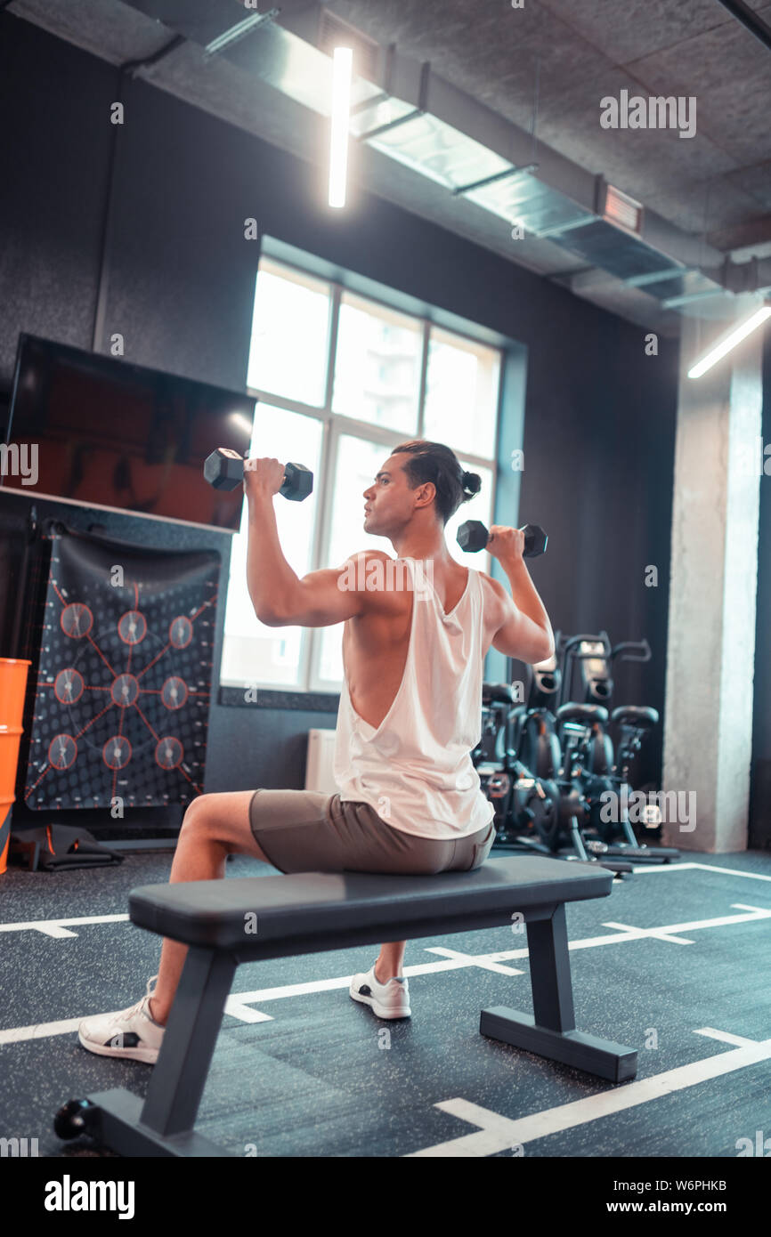 Nice good looking man doing a physical exercise Stock Photo - Alamy