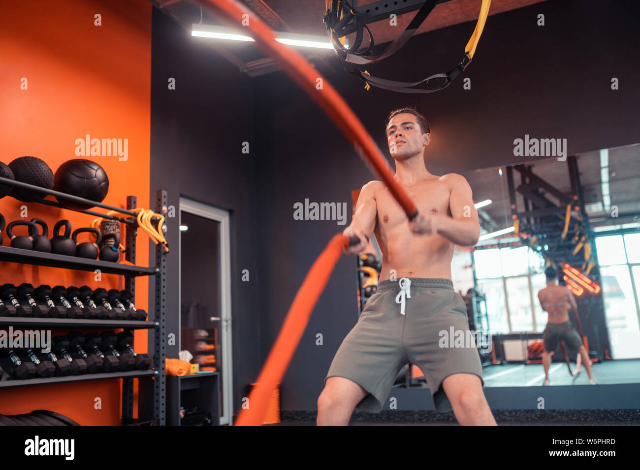 Serious young man holding ropes in his hands Stock Photo - Alamy