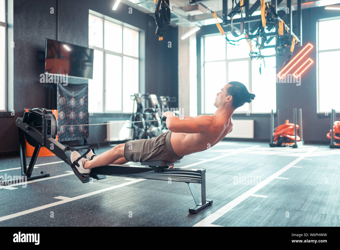 Strong good looking man pulling weight on himself Stock Photo - Alamy