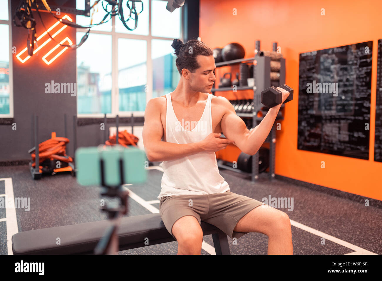 Fit well built man showing his muscular arm Stock Photo - Alamy