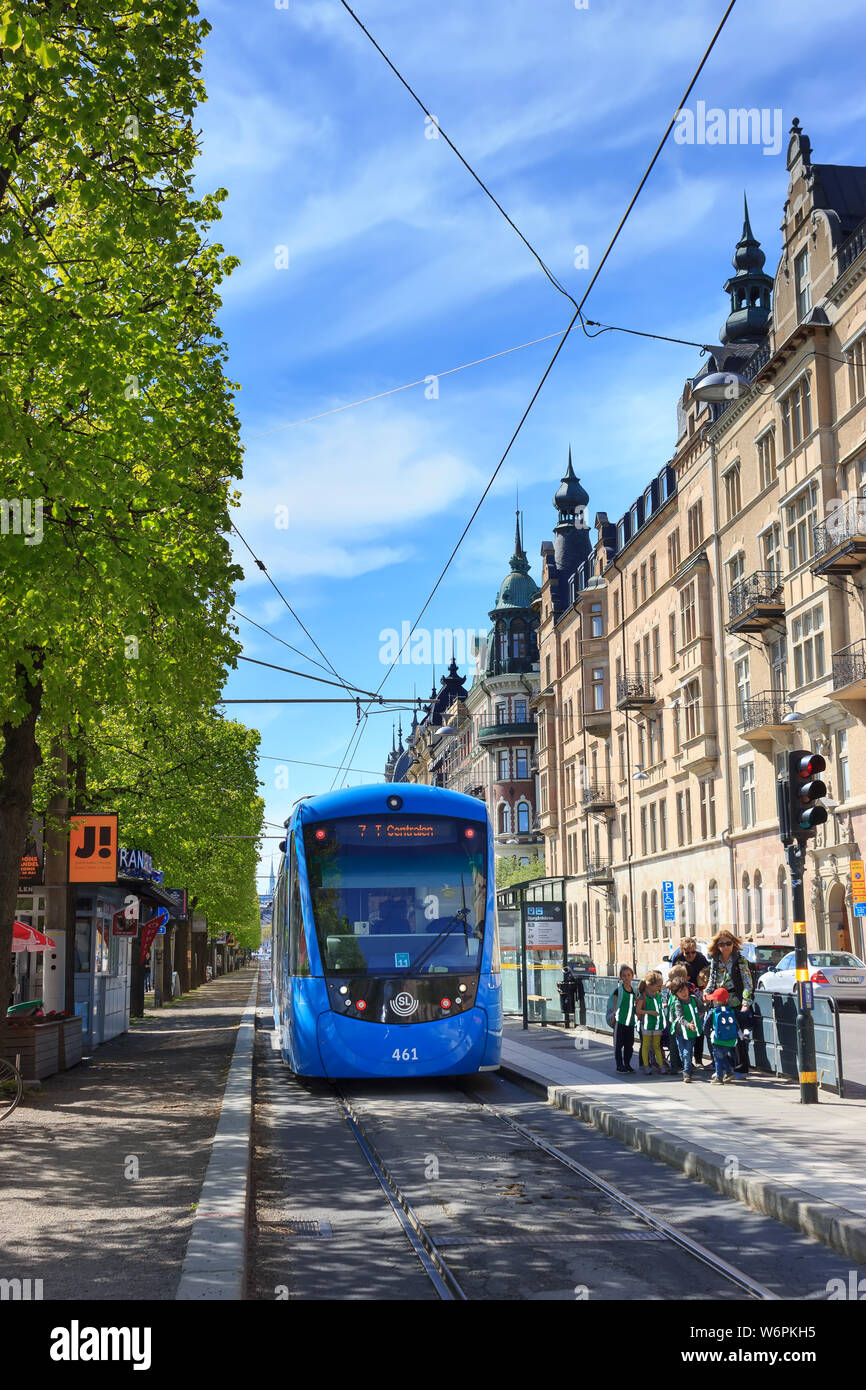 SL or Storstockholms Lokaltrafik blue tramway and passengers waiting at ...