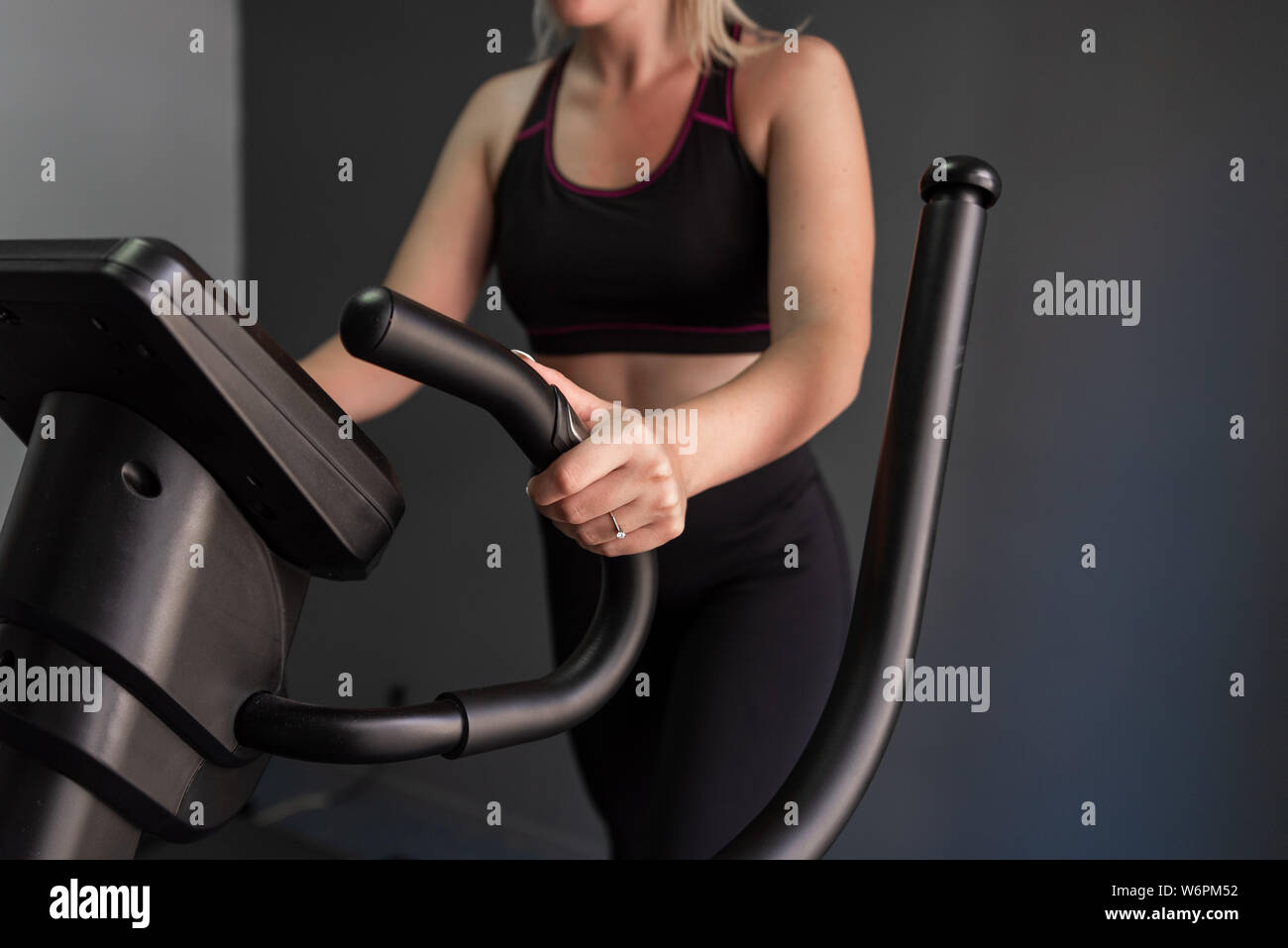 Woman Exercise Elliptical cardio running workout at fitness gym Stock ...