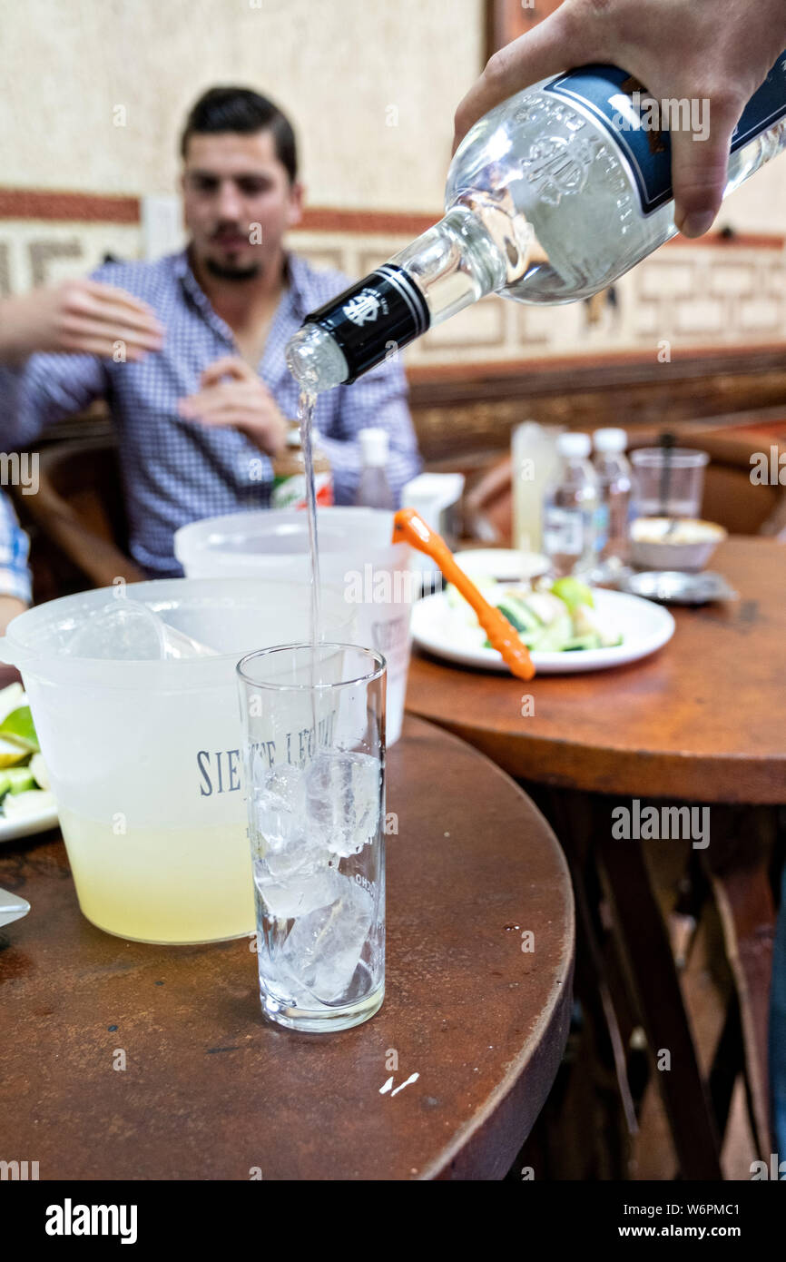 A waiter serves Siete Leguas blanco tequila at the Fellos Bar in ...
