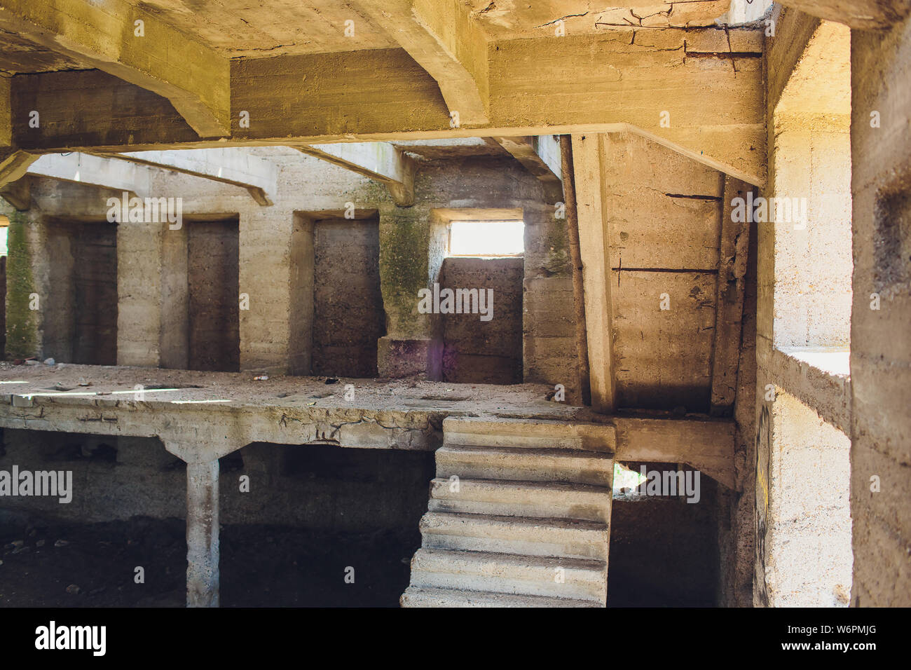 The destroyed big concrete building in a foggy haze. The remains of the ...