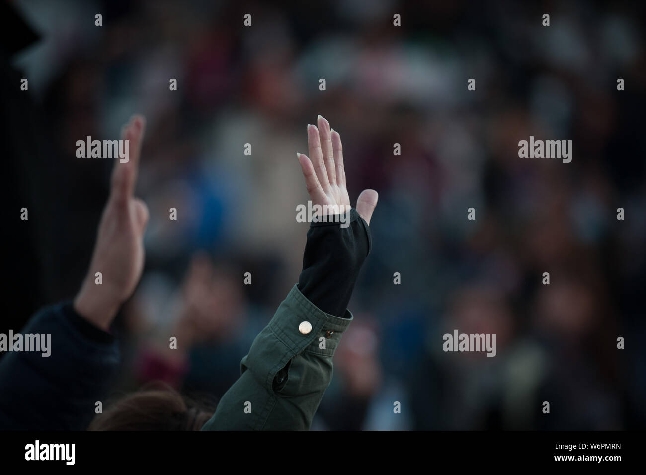 people hands up with a blur background Stock Photo - Alamy