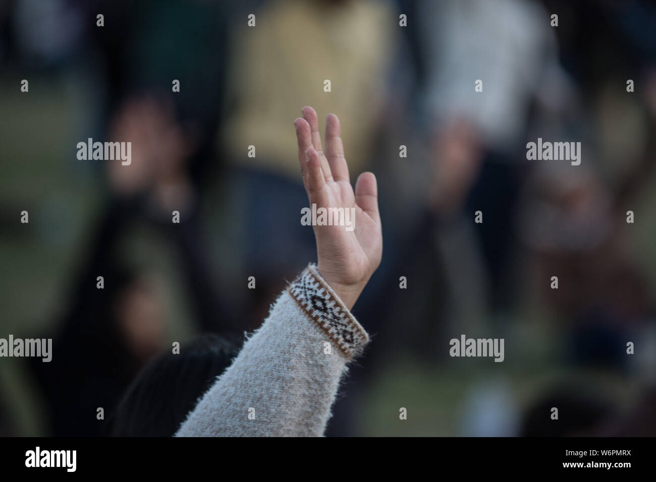 people hands up with a blur background Stock Photo - Alamy
