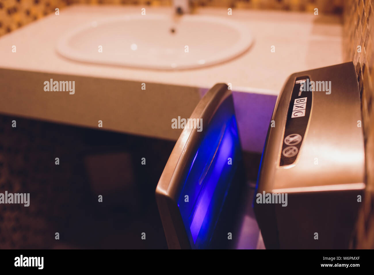 Modern vertical hand dryer in public restroom WC Stock Photo - Alamy