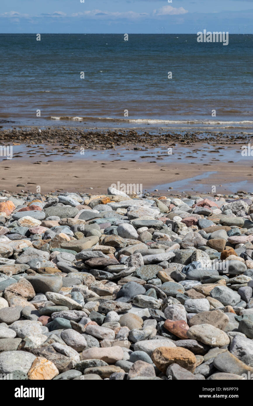 Rocks sand and water on the beach at Llandudno North Wales May 2019 ...