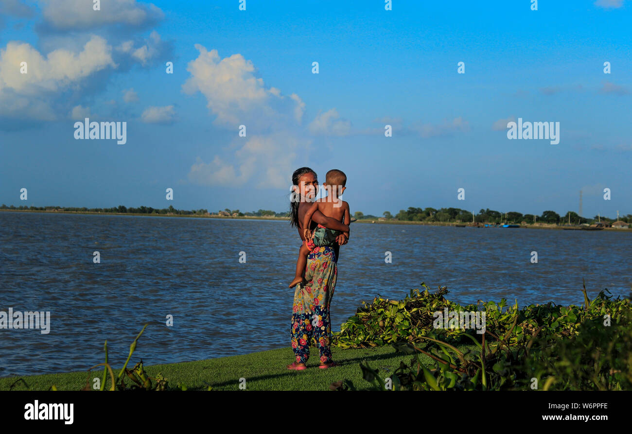 Elder sister carrying younger brother hi-res stock photography and images - Alamy