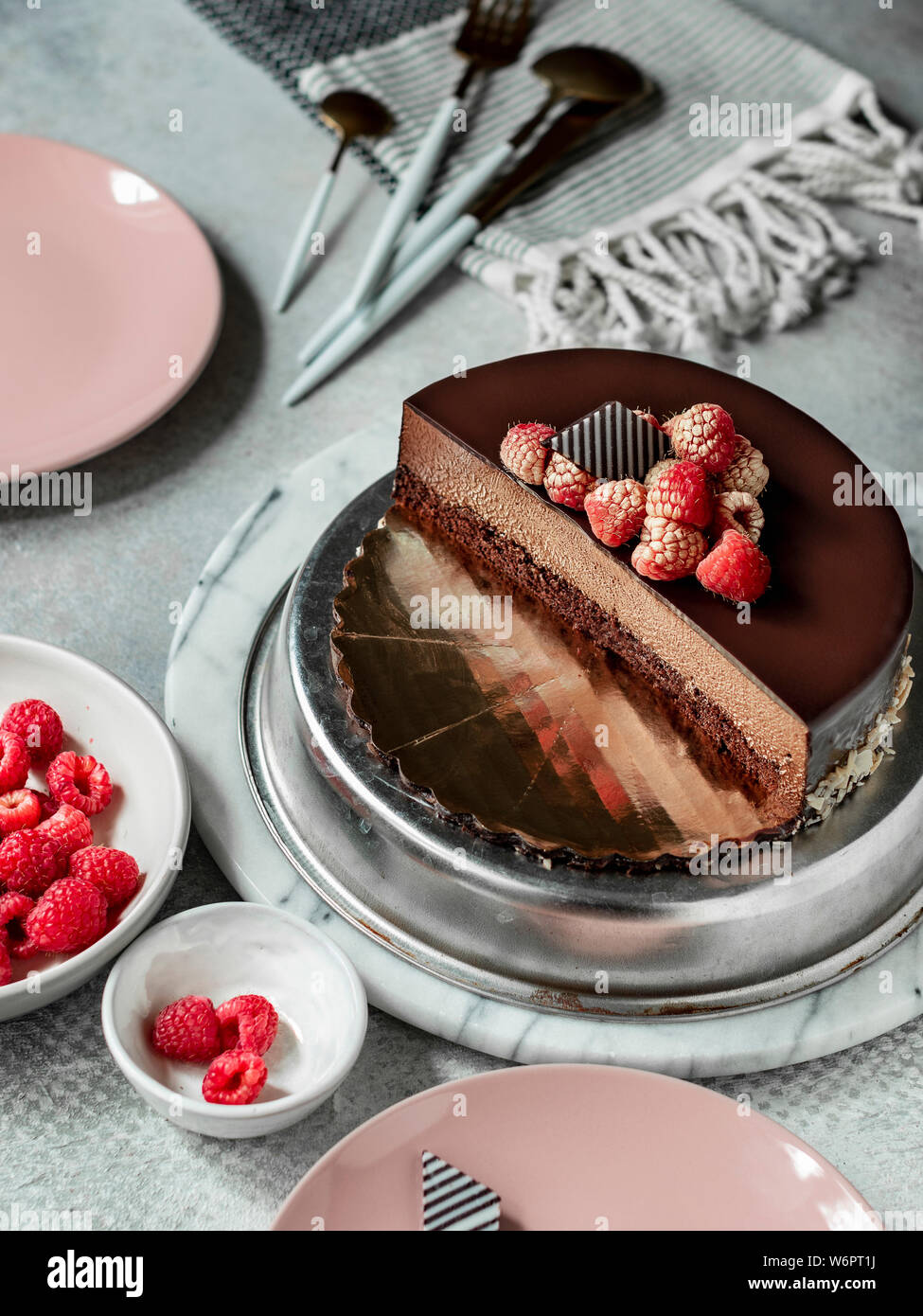 Chocolate truffle cake with raspberries and chocolate decoration on top ...