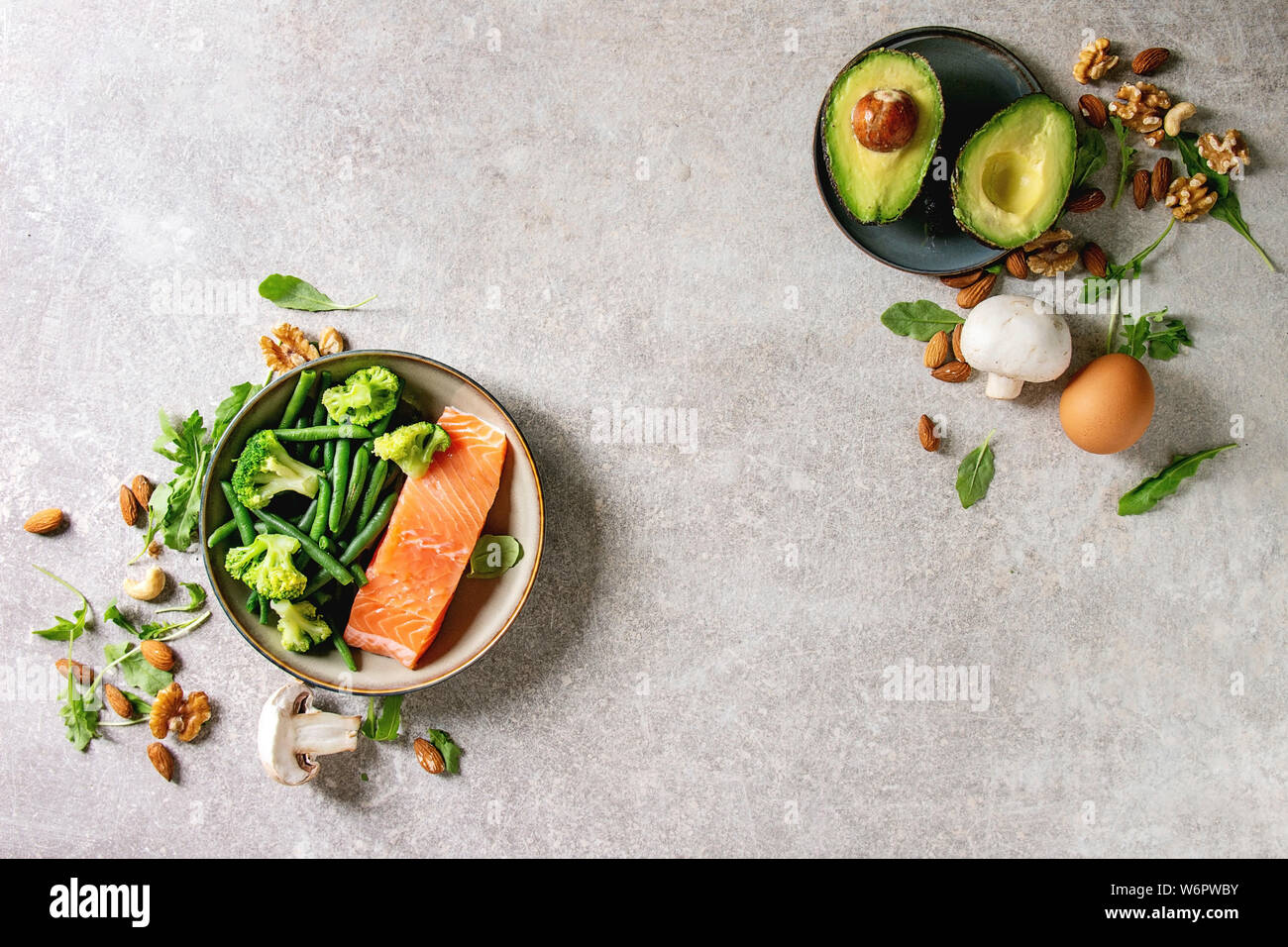 Ketogenic diet ingredients for cooking dinner. Raw salmon, avocado ...