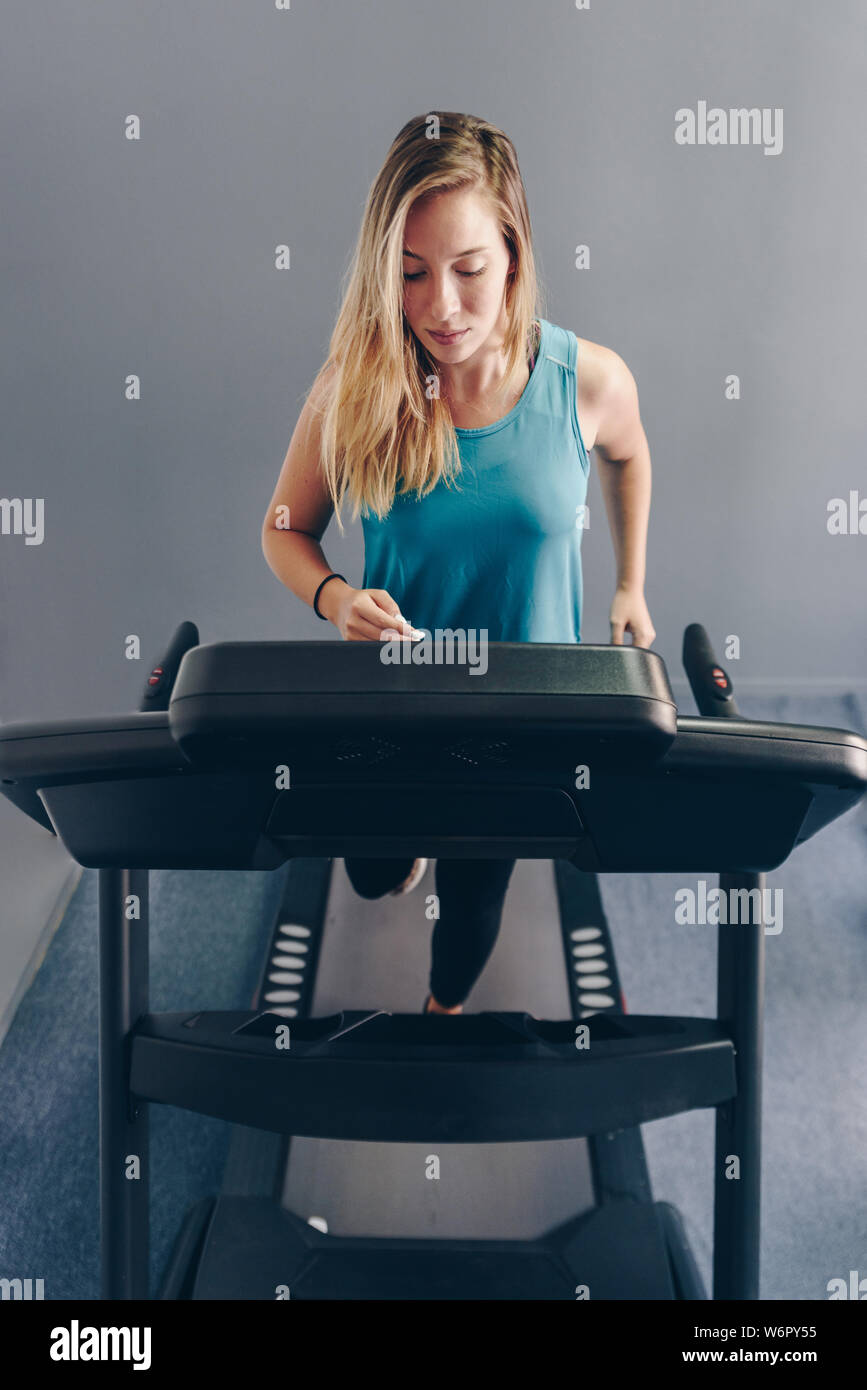 Fitness girl running on treadmill Stock Photo - Alamy