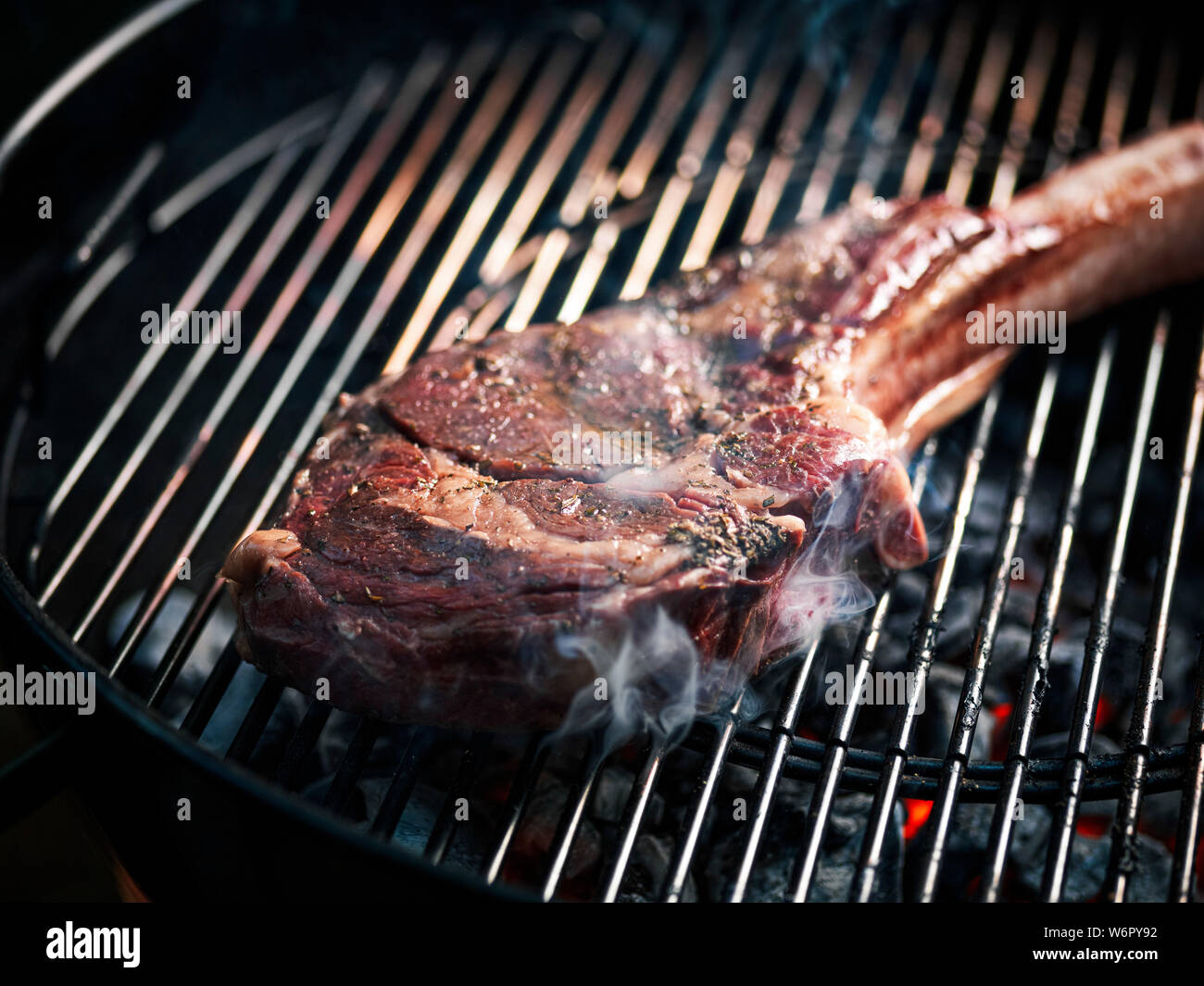 Angus beef tomahawk steak being grilled on a BBQ Stock Photo - Alamy