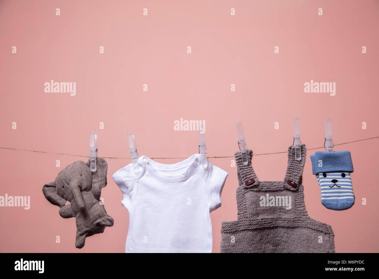 A set of cute newborn baby clothes and toys hanging on a line Stock ...