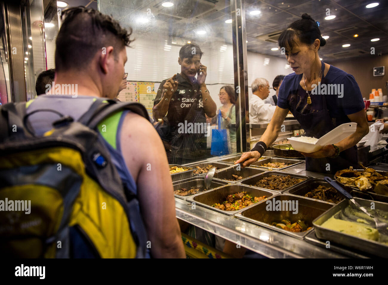 People in a queue for a take-away restaurant. Hong Kong Stock Photo - Alamy